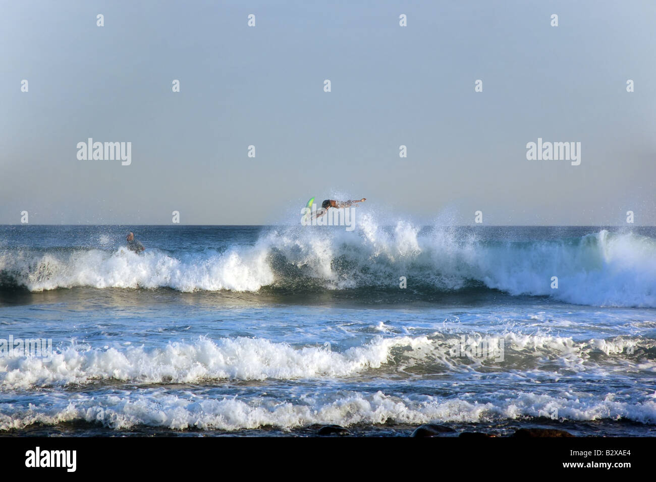 A surfer catches a wave near Playa El Zonte, El Salvador Stock Photo ...