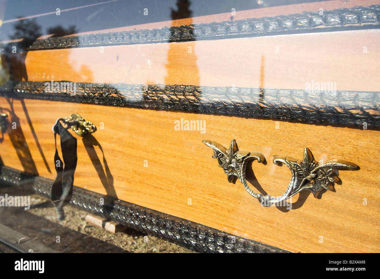 Wood coffin seen through a glass window, in a Catholic Cemetery ...