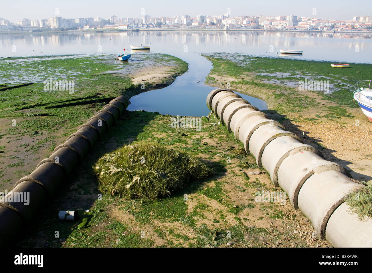 Open air sewer pipes draining to the Seixal Bay, a Tagus River branch ...