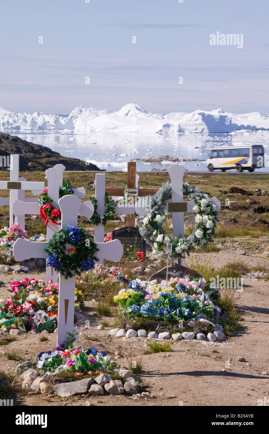 An Inuit burial graveyard at Ilulissat on Greenland with ice bergs from ...