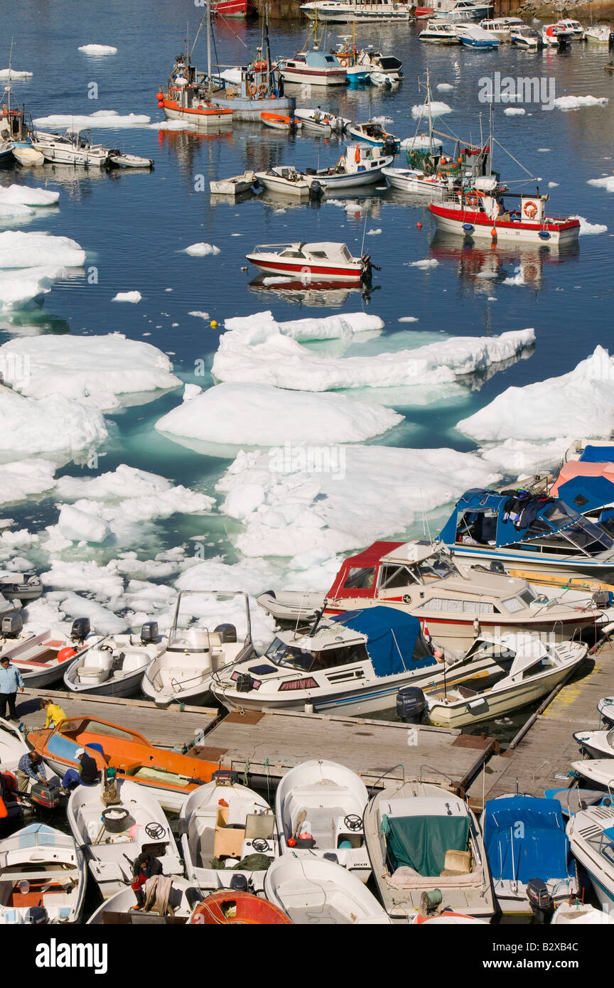 Inuit boats and icebergs in Illulissat harbour on Greenland Stock Photo ...