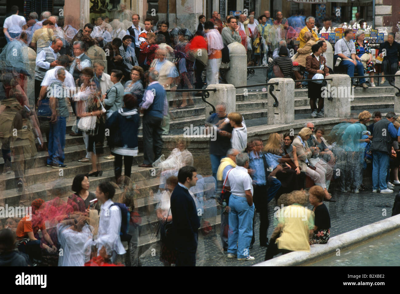 Multiple exposure crowd scene of tourists on steps in front of the ...