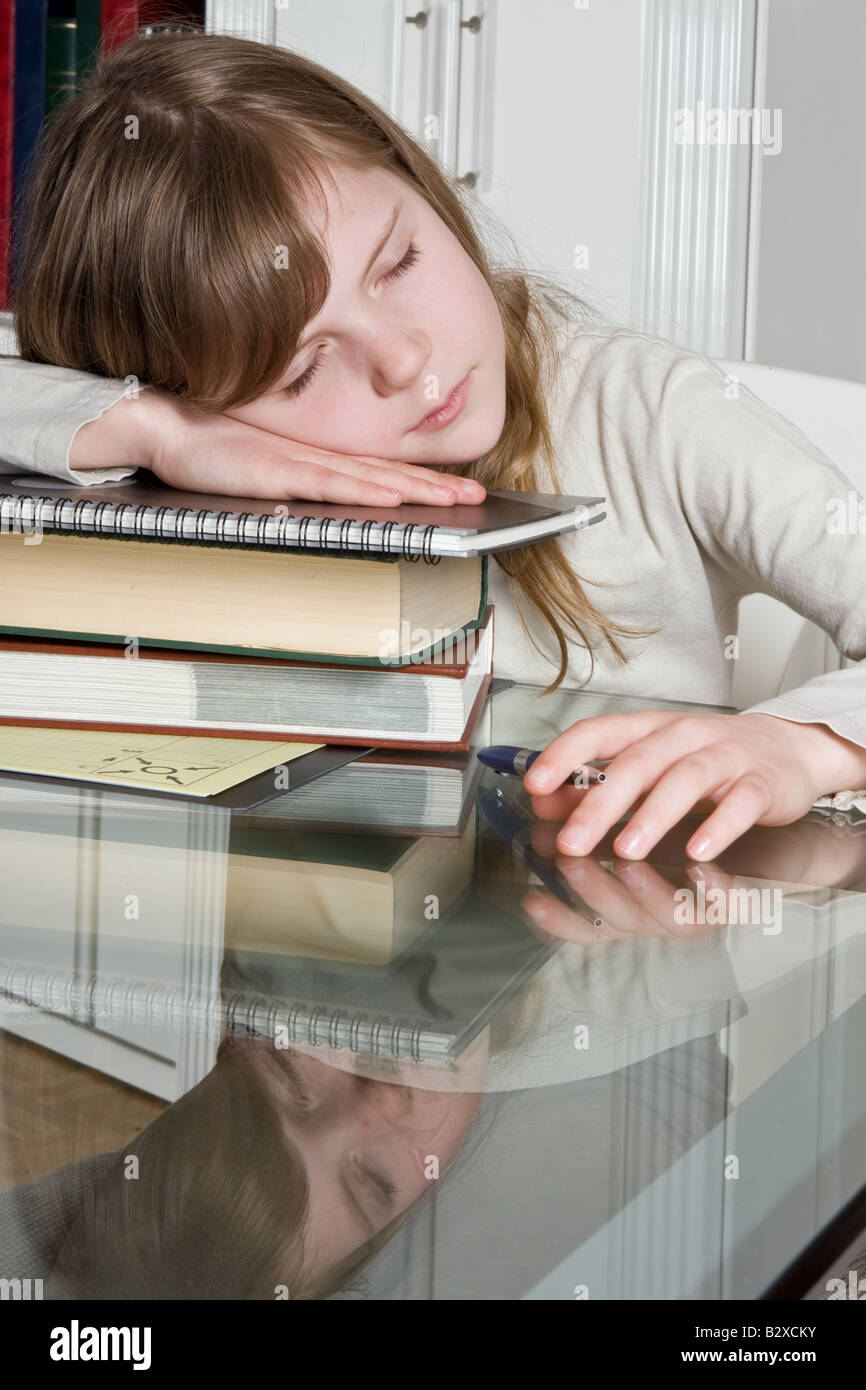 Young teenager girl fallen asleep over her homework Stock Photo - Alamy