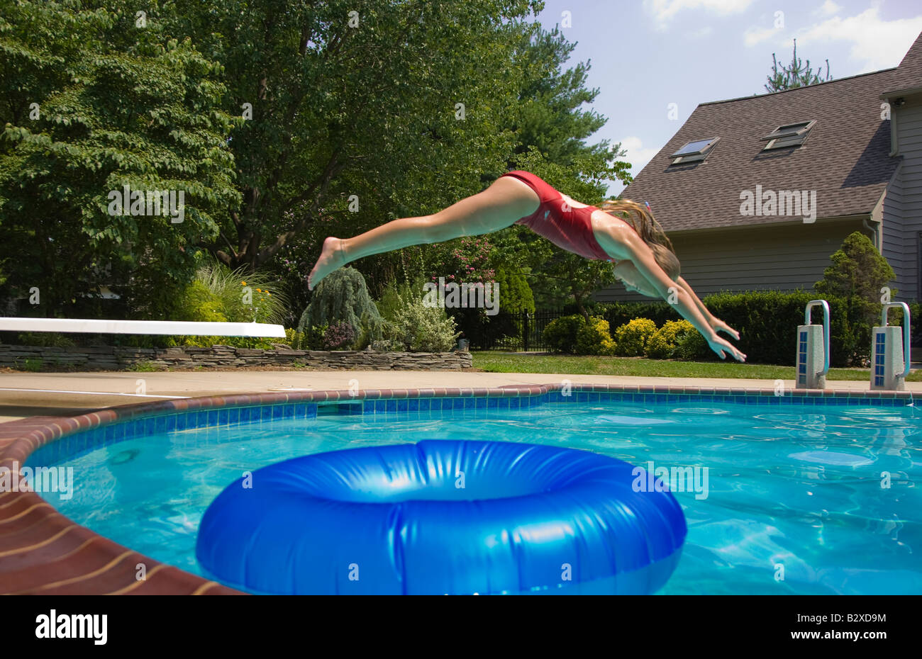 Child diving into backyard swimming pool Stock Photo - Alamy