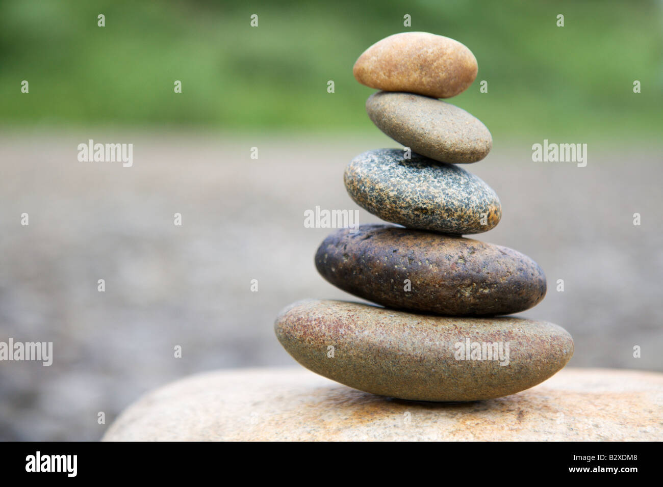 Zen like stones stack on the big stone Stock Photo - Alamy