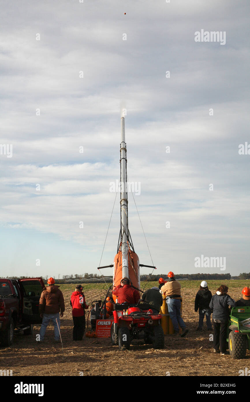 small orange cylinders air cannon with long gray barrel pointed ...