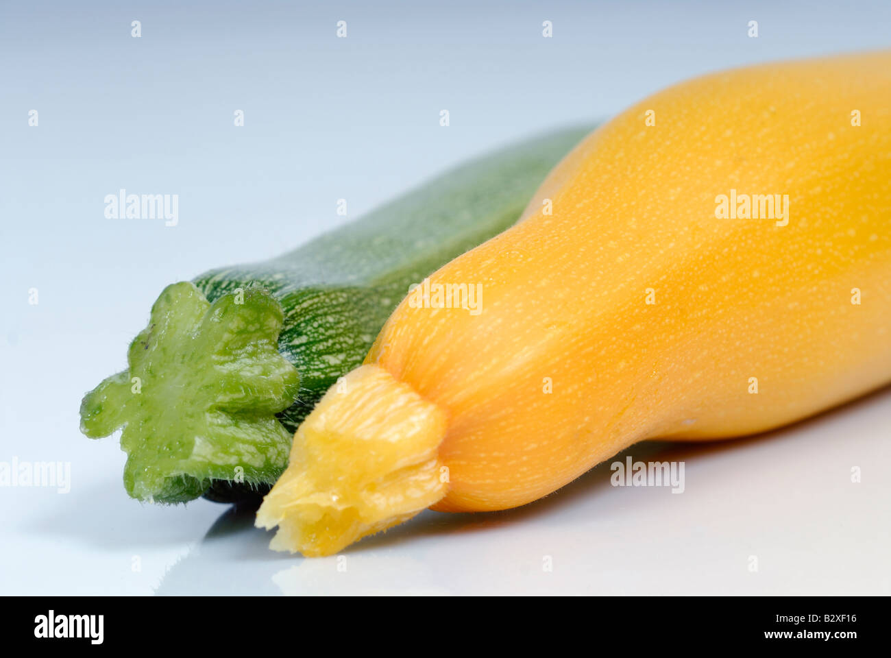 Stock photo of yellow and green courgettes against a white background ...