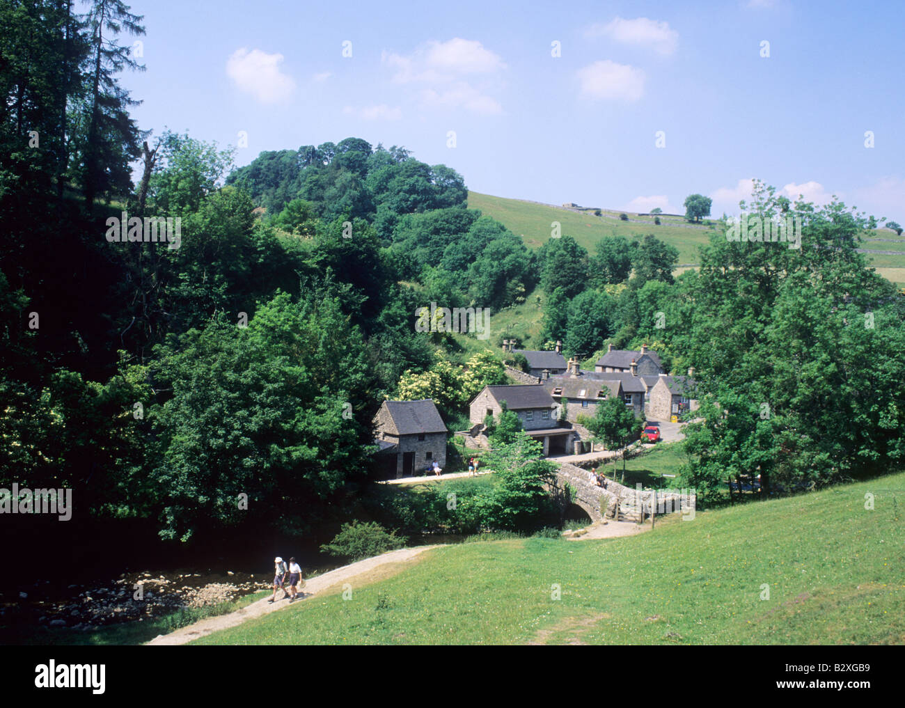 Milldale village Derbyshire Dales valley hills green fields trees woods ...