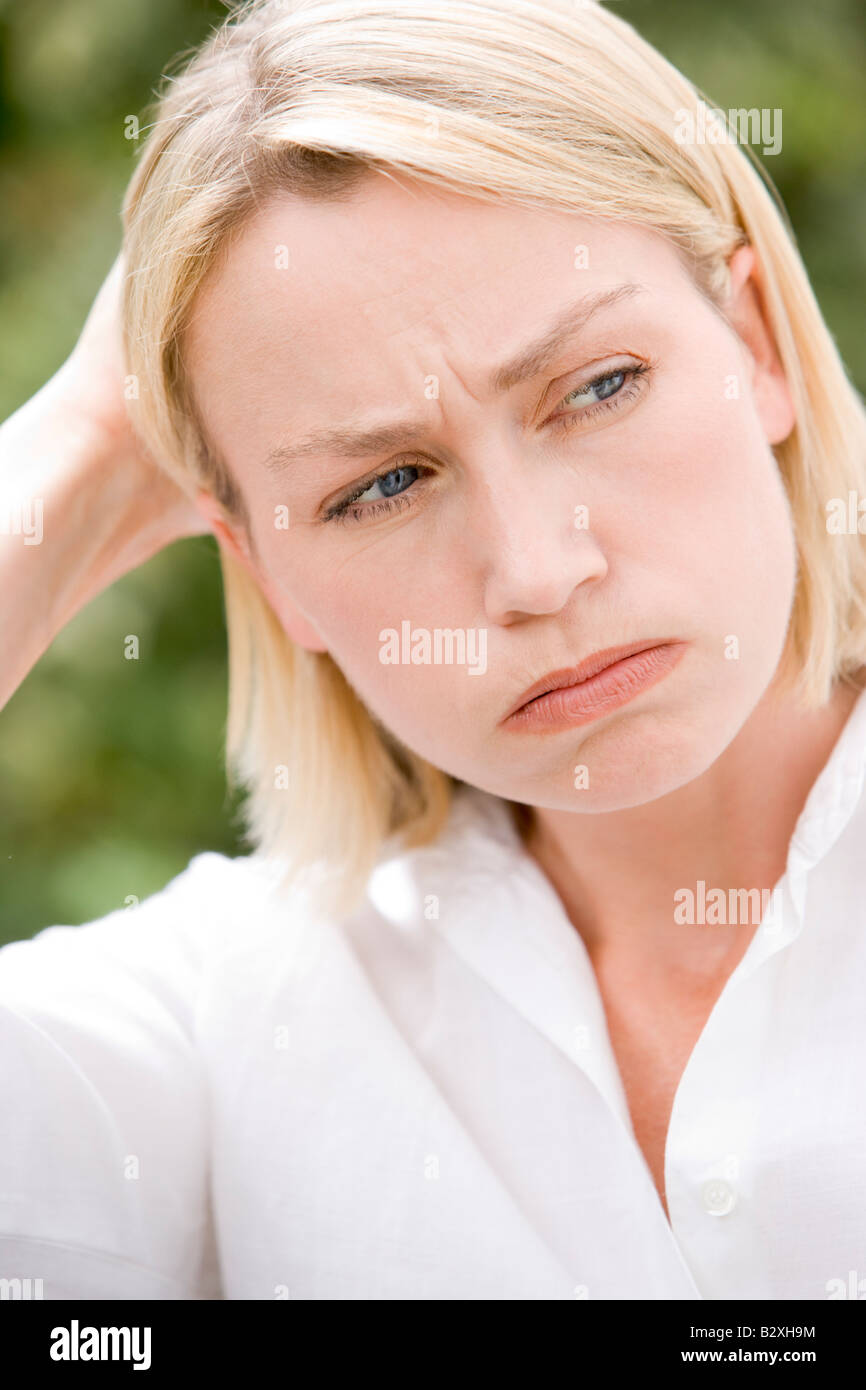 Head shot of woman scowling Stock Photo - Alamy