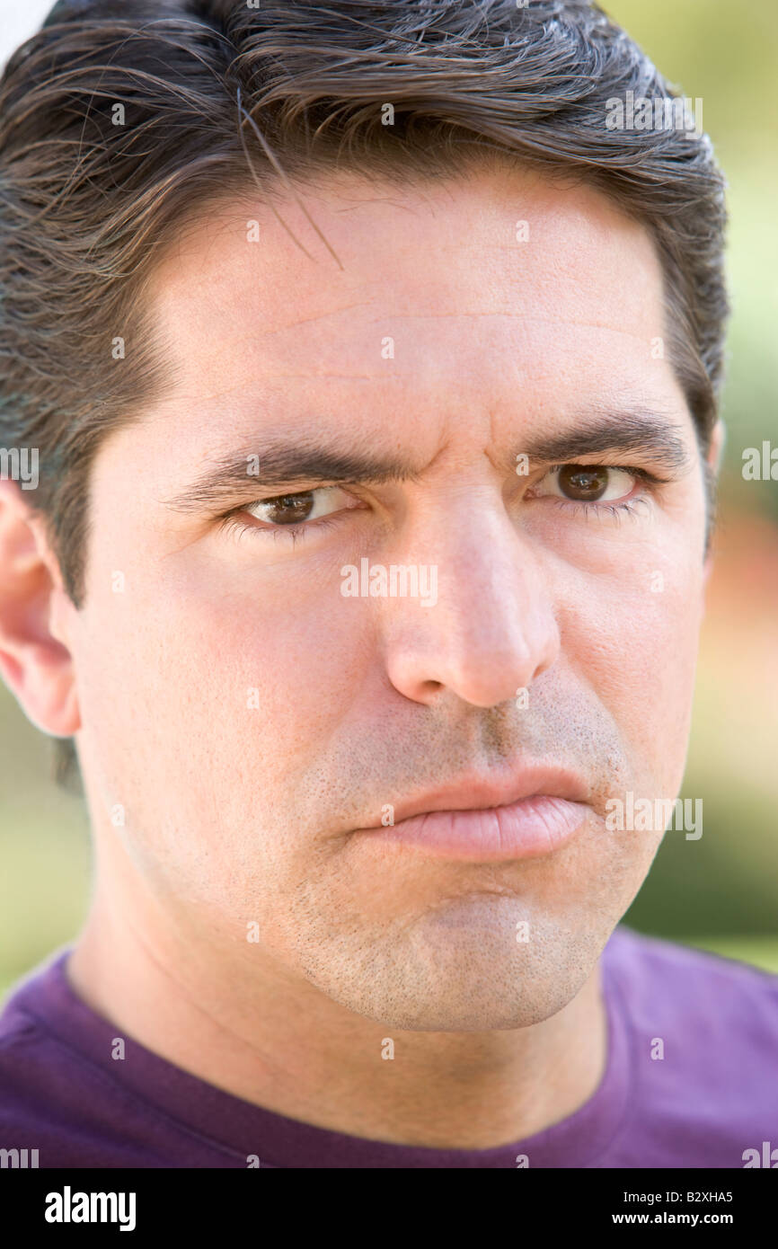 Head shot of man scowling Stock Photo - Alamy
