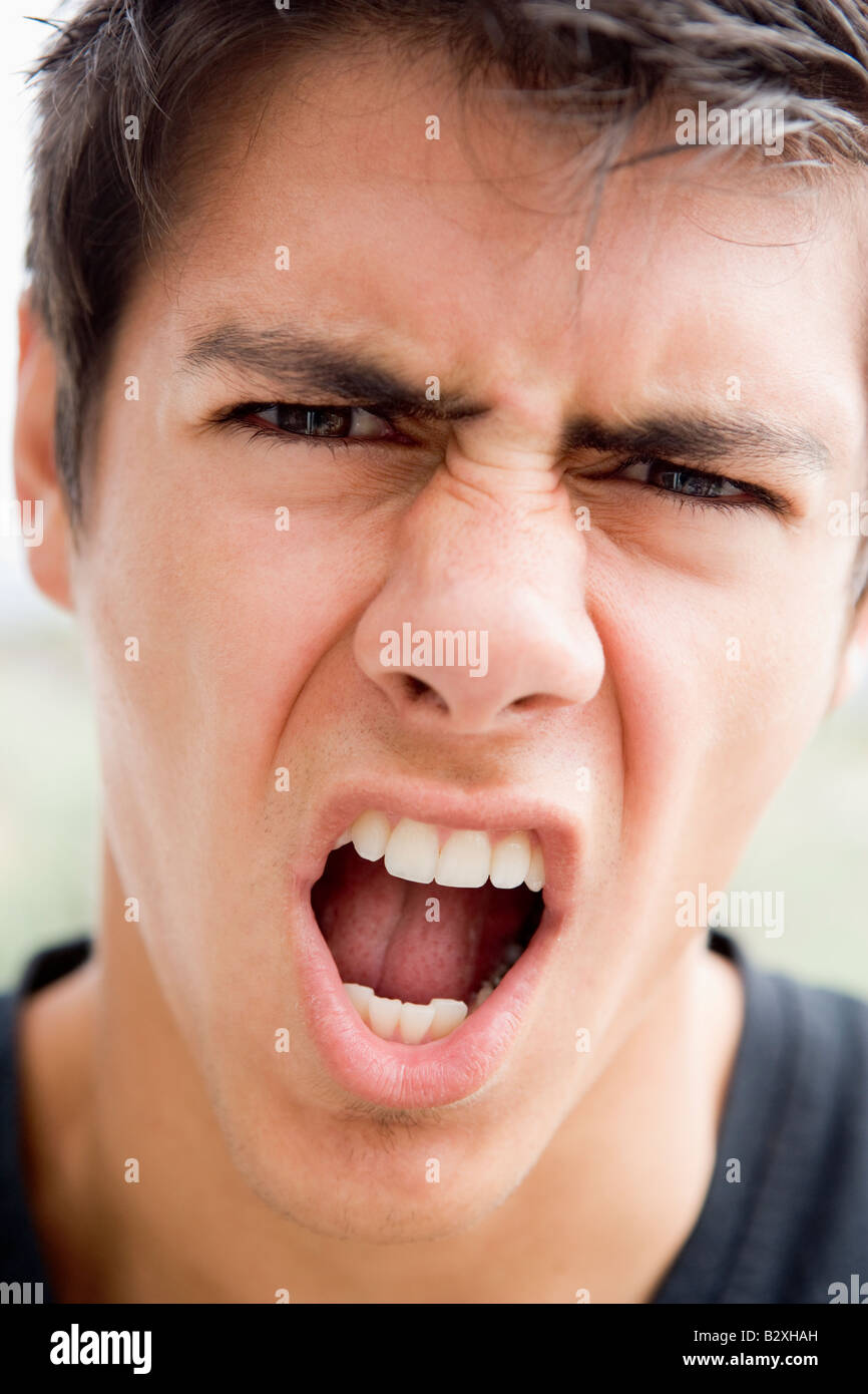 Head shot of man scowling Stock Photo - Alamy