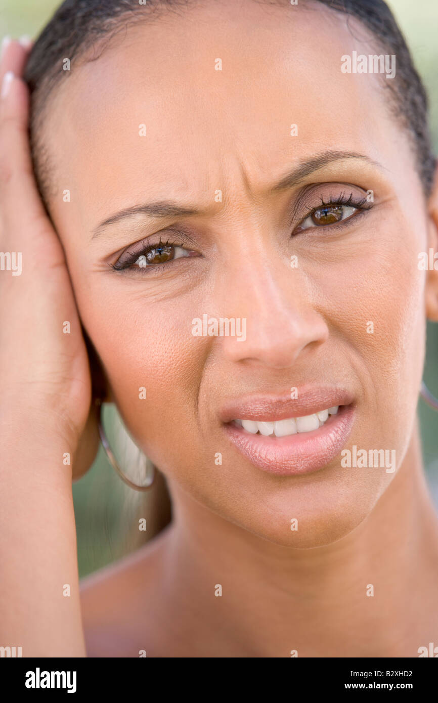 Head shot of woman scowling Stock Photo - Alamy