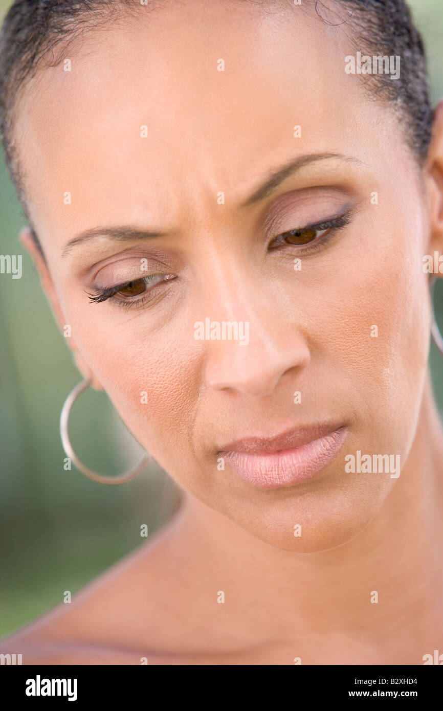 Head shot of woman scowling Stock Photo - Alamy