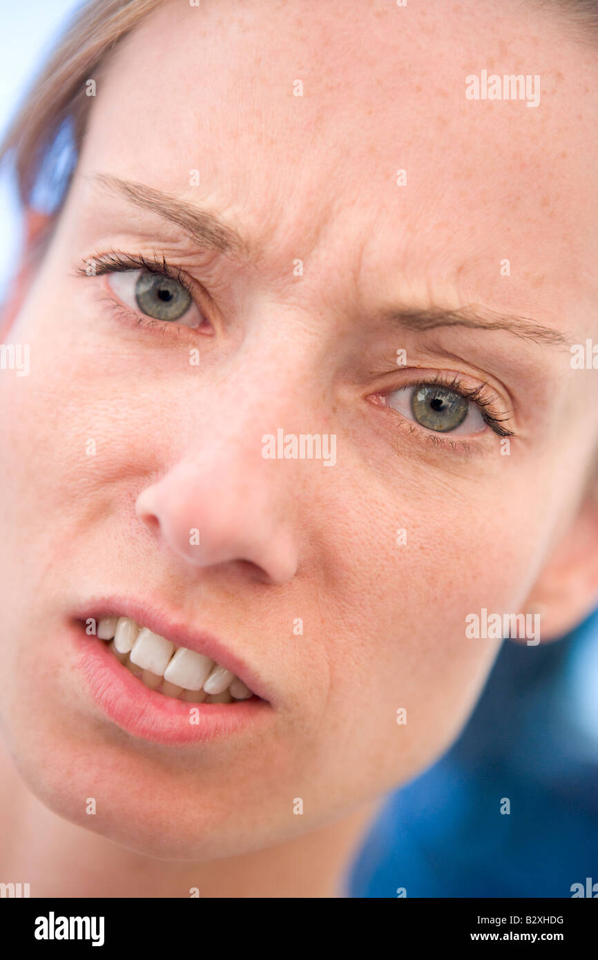 Head shot of woman scowling Stock Photo - Alamy