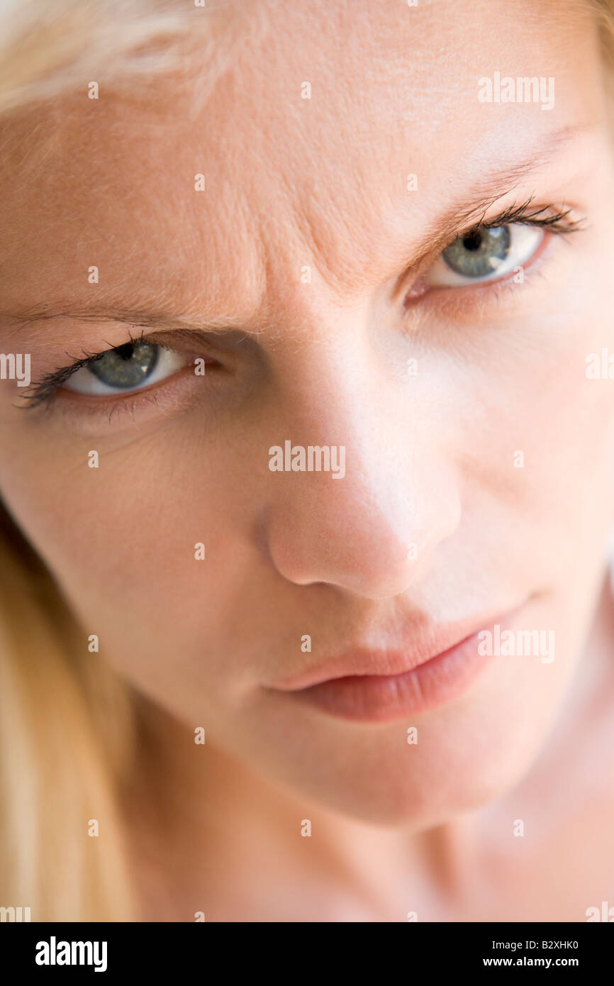 Head shot of woman scowling Stock Photo - Alamy
