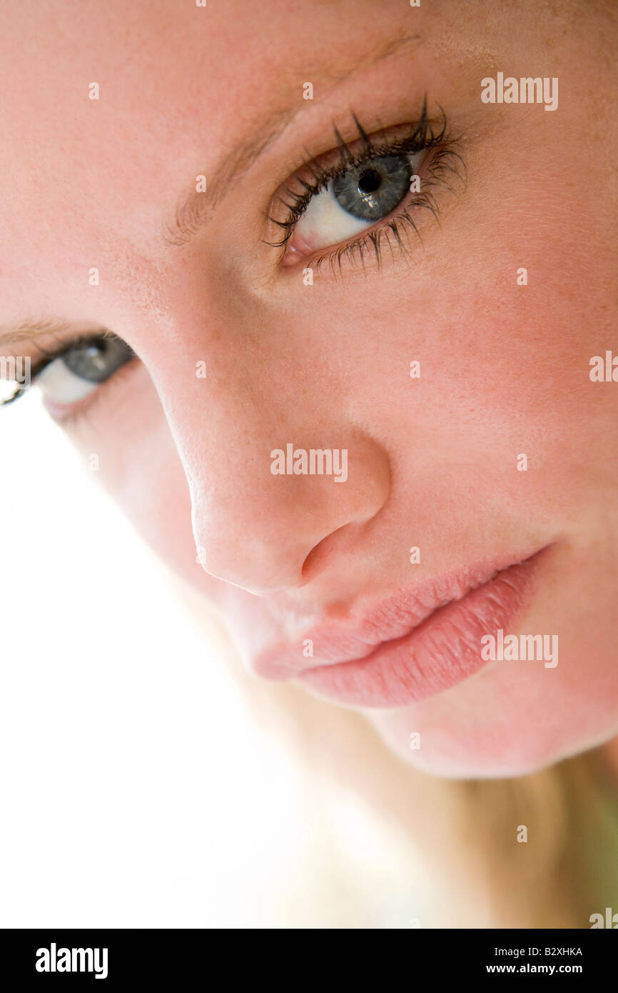 Head shot of woman scowling Stock Photo - Alamy