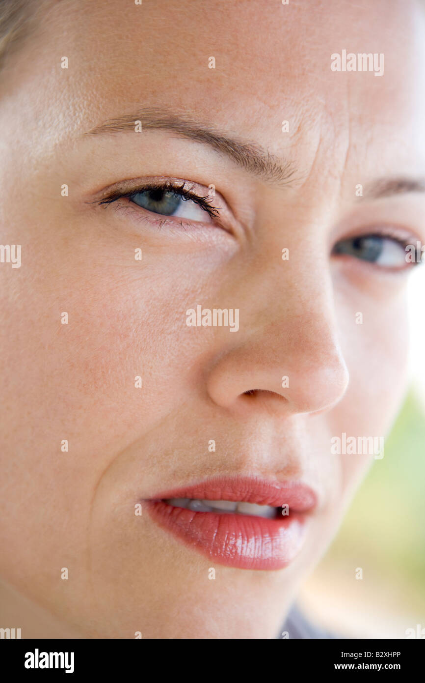 Head shot of woman scowling Stock Photo - Alamy