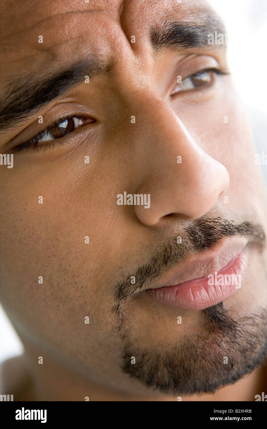 Head shot of man scowling Stock Photo - Alamy