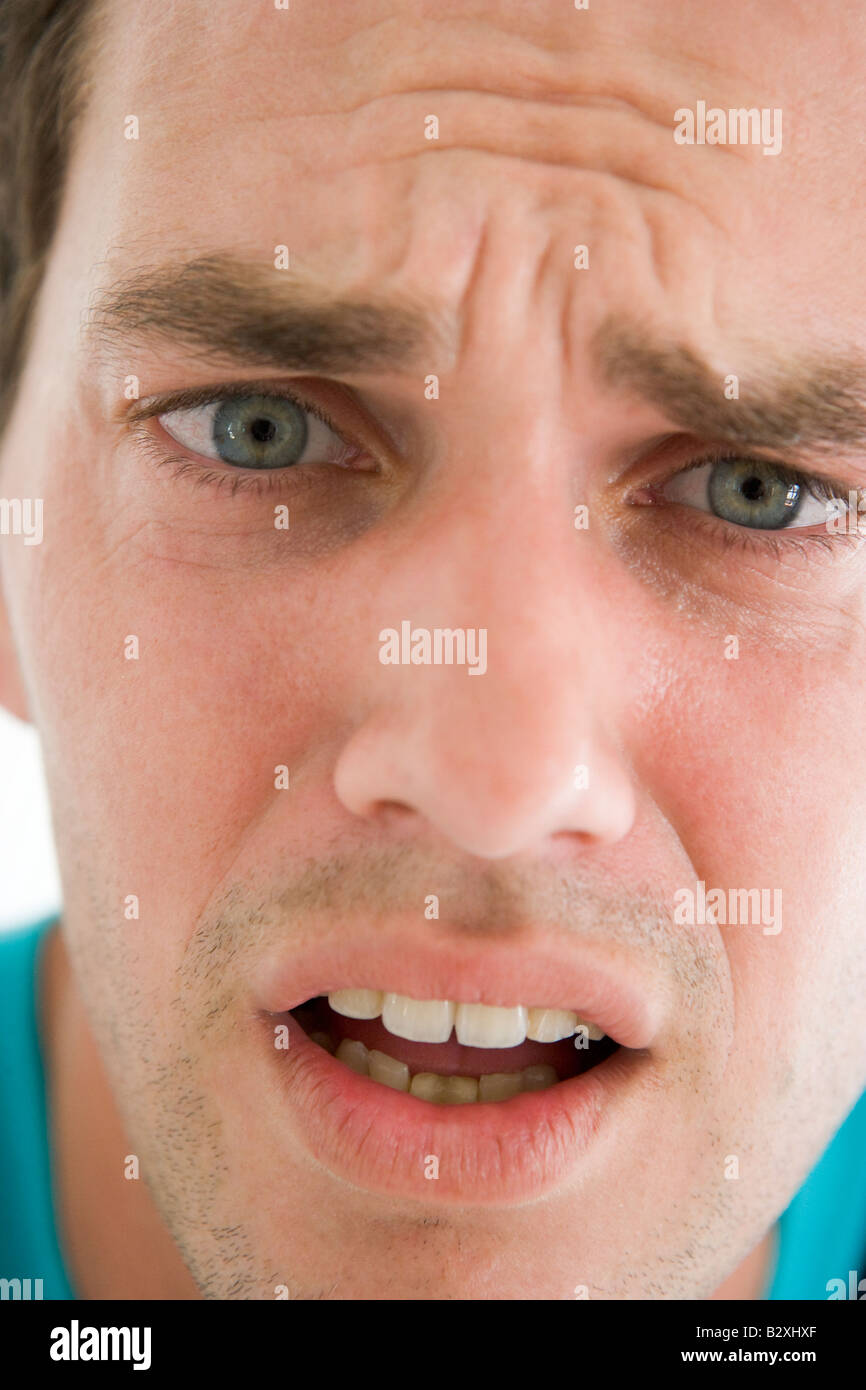 Head shot of man scowling Stock Photo - Alamy