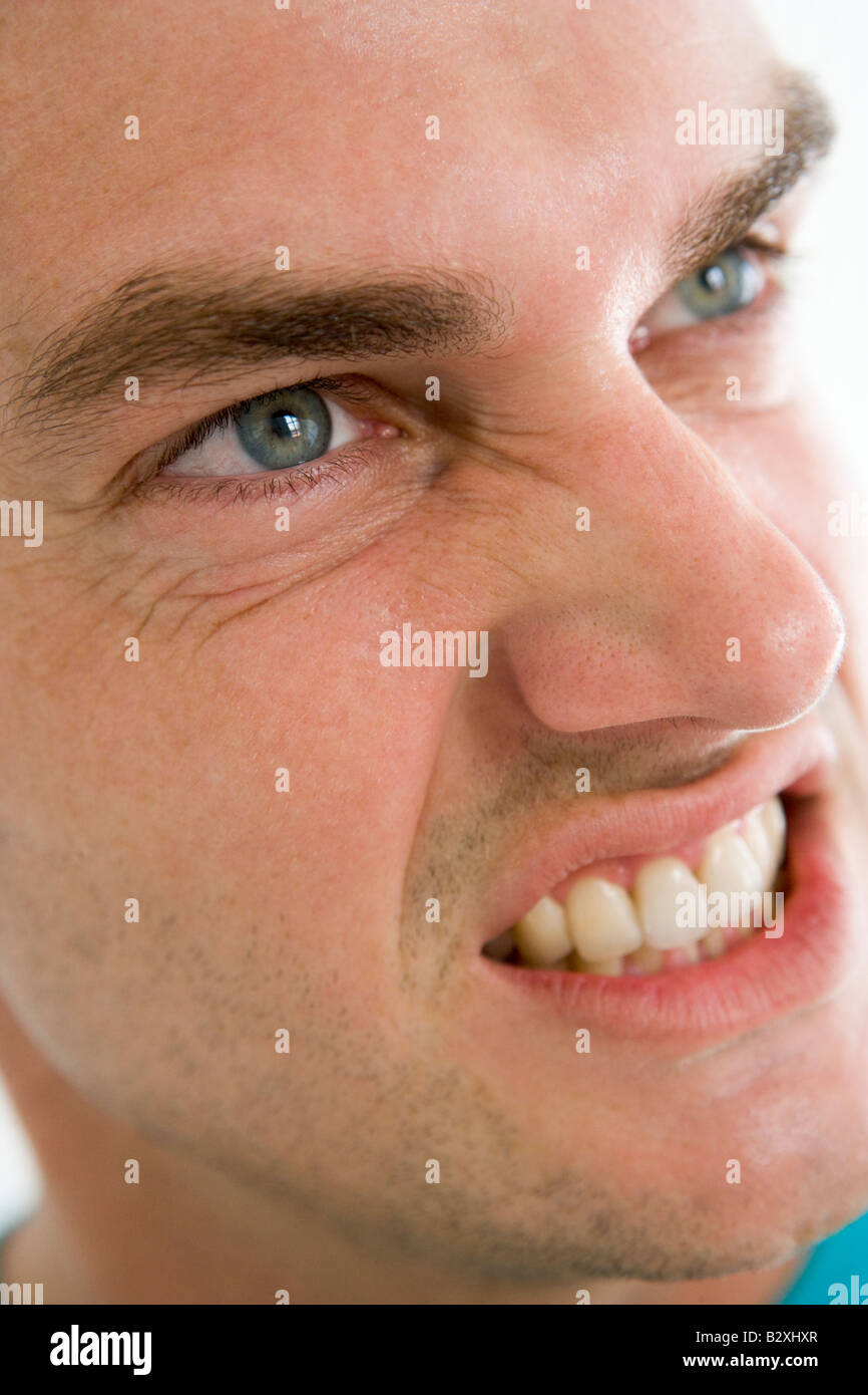 Head shot of man scowling Stock Photo - Alamy