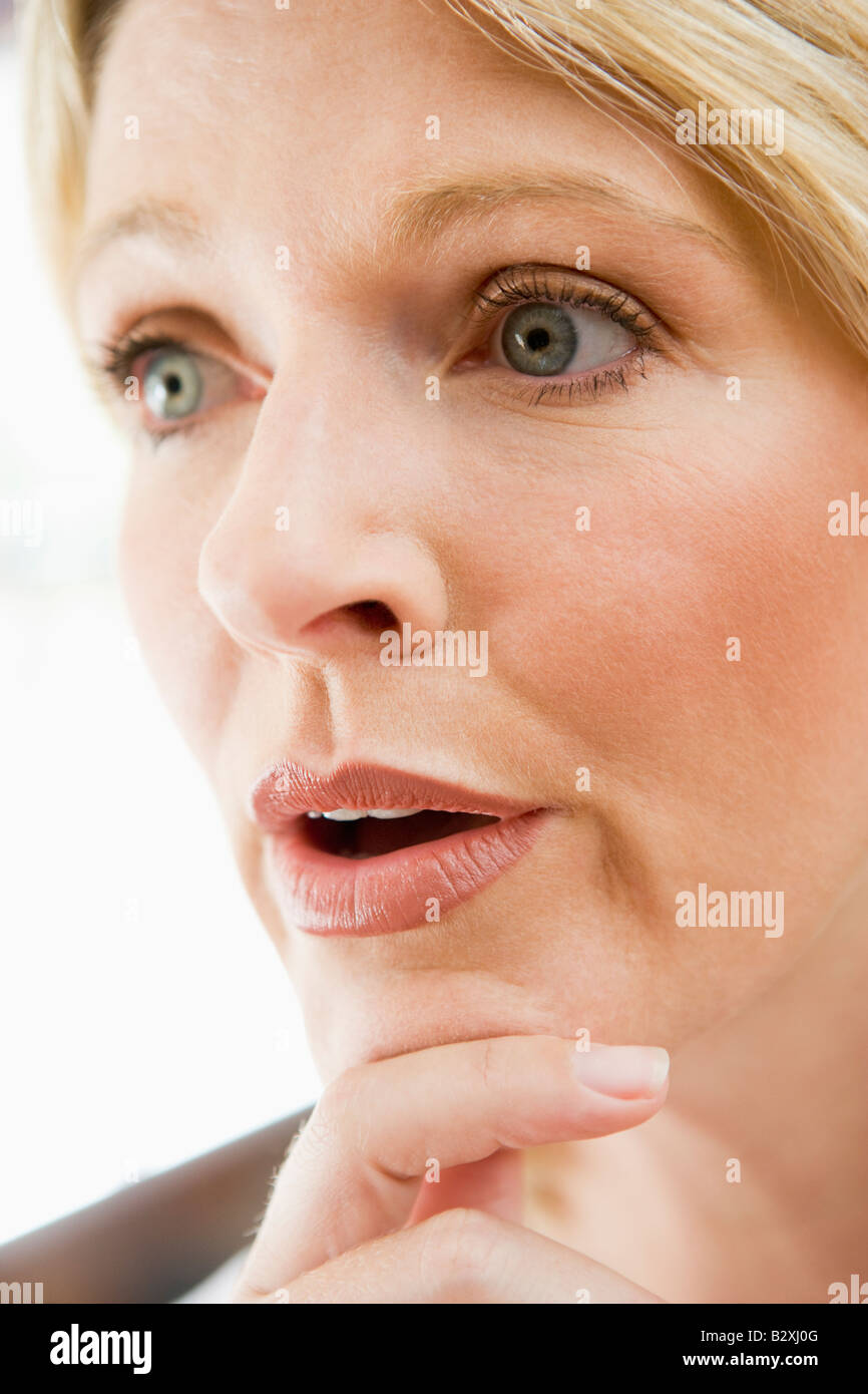 Head shot of woman thinking Stock Photo - Alamy