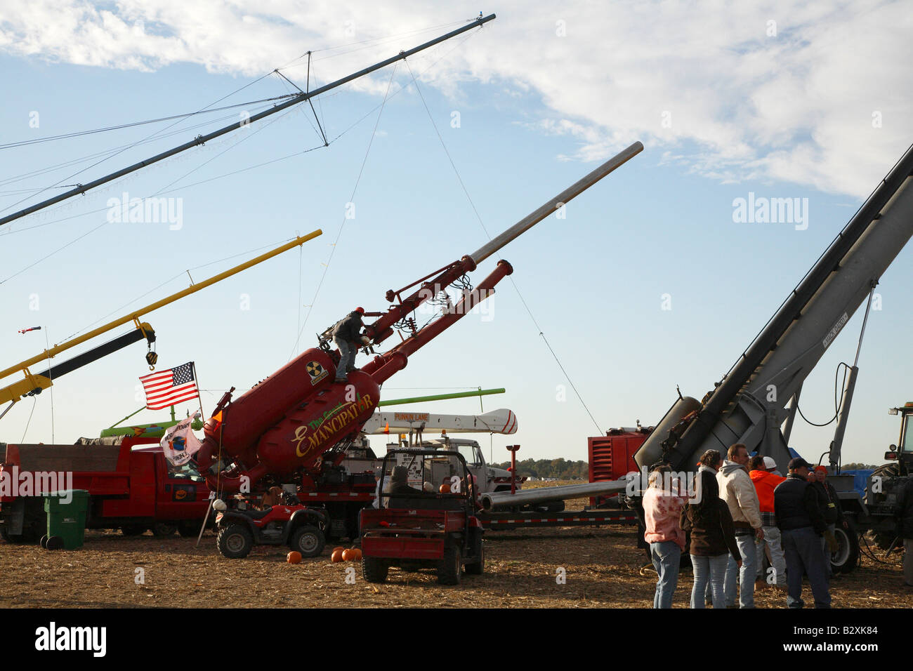 Smaller chunky orange air cannon with man standing up on gas cylinder ...
