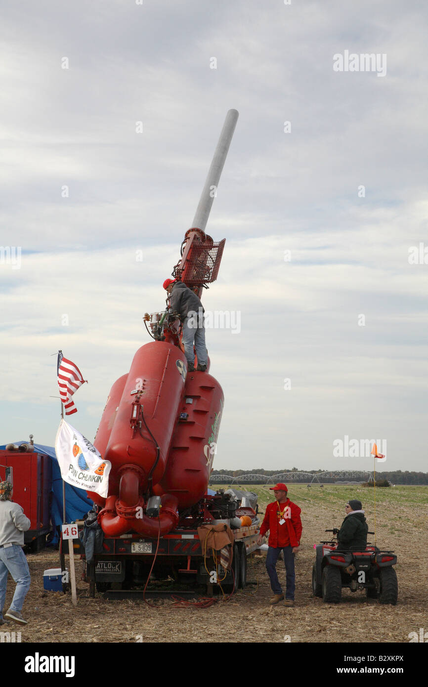 air cannon with man standing on base of gas tanks loading pumpkin into ...