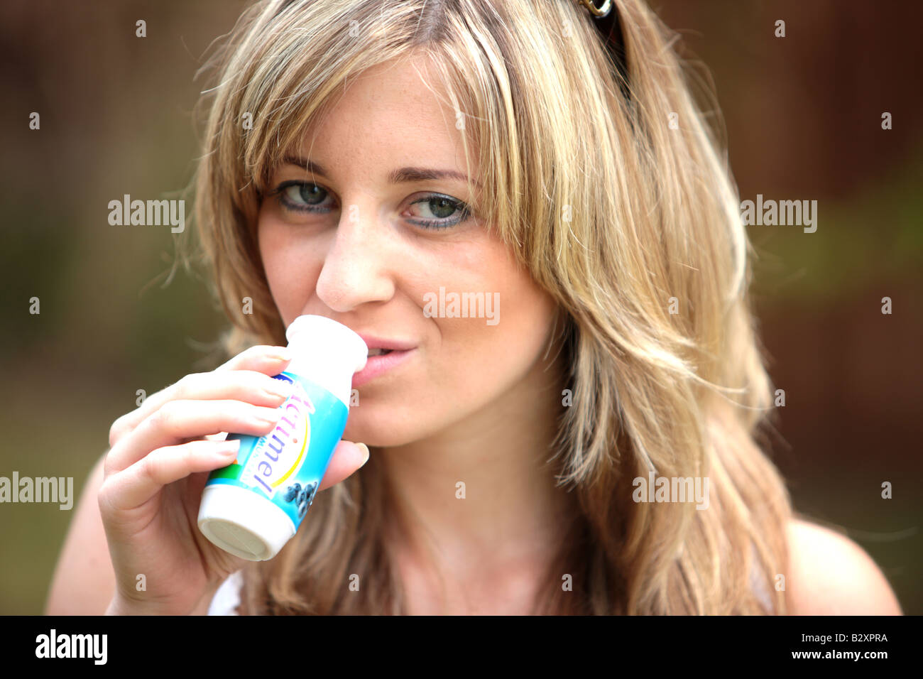 Young Woman Drinking Yogurt Drink Model Released Stock Photo - Alamy