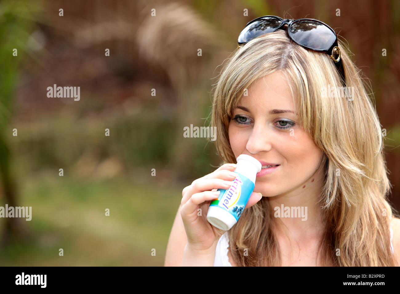 Young Woman Drinking Yogurt Drink Model Released Stock Photo - Alamy