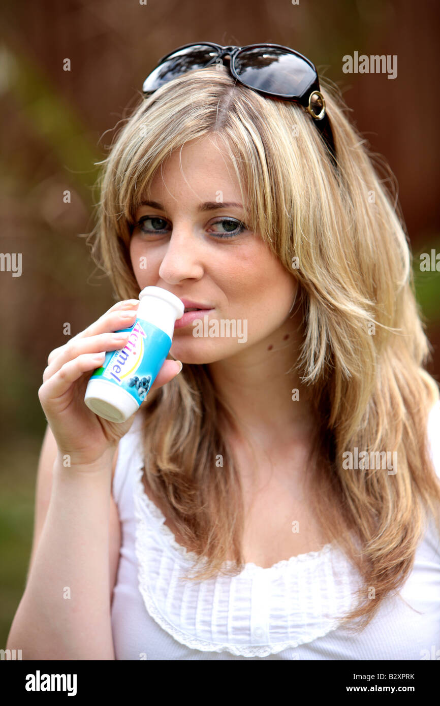 Young Woman Drinking Yogurt Drink Model Released Stock Photo - Alamy