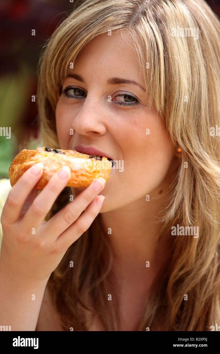 Young Woman Eating Cinnamon Raisin Bun Model Released Stock Photo - Alamy
