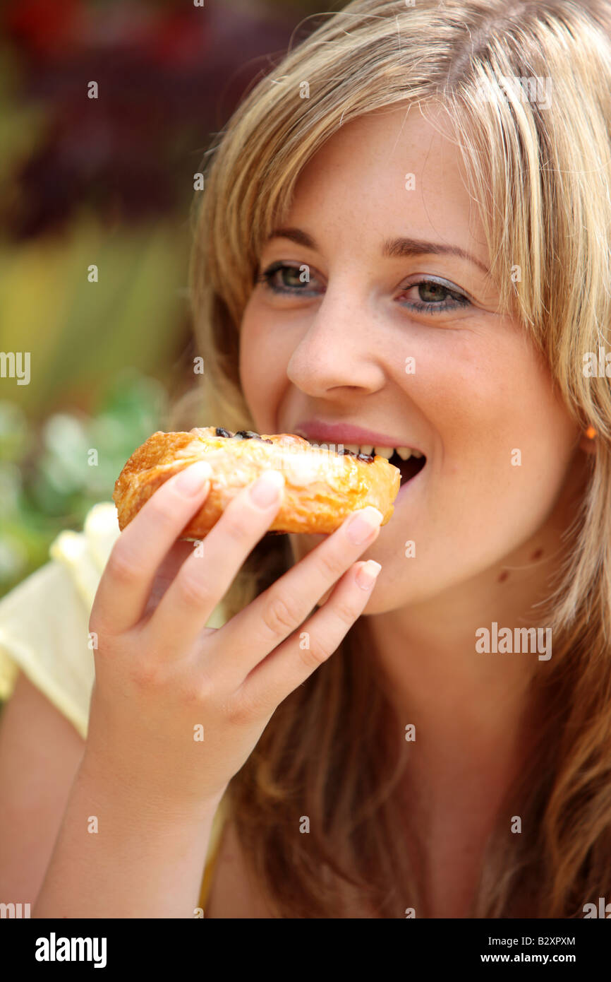 Young Woman Eating Cinnamon Raisin Bun Model Released Stock Photo - Alamy