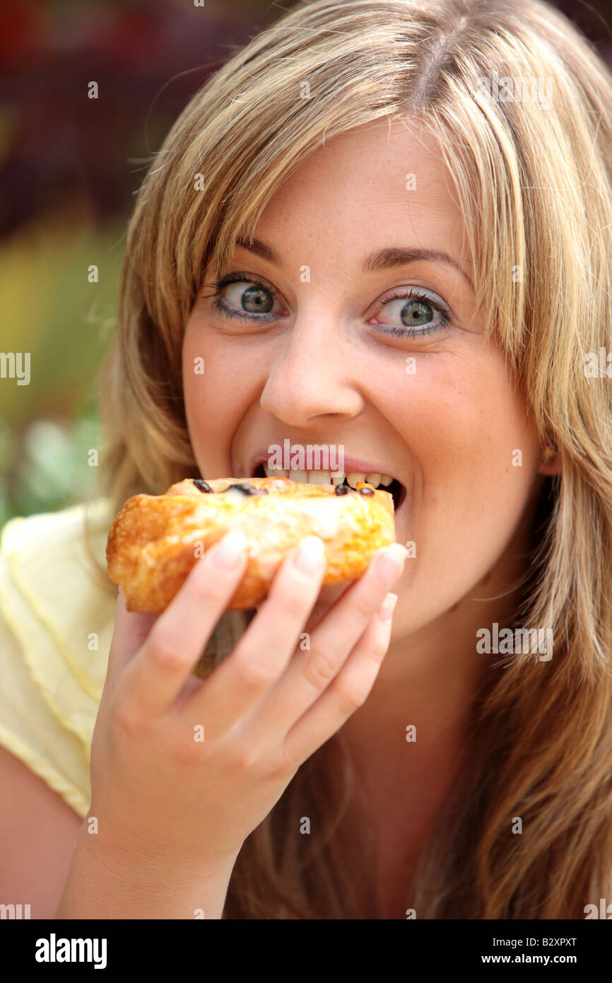 Young Woman Eating Cinnamon Raisin Bun Model Released Stock Photo - Alamy