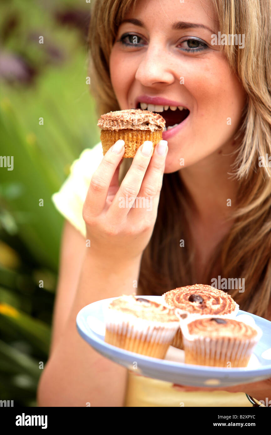 Young Woman Eating Cupcakes Model Released Stock Photo - Alamy