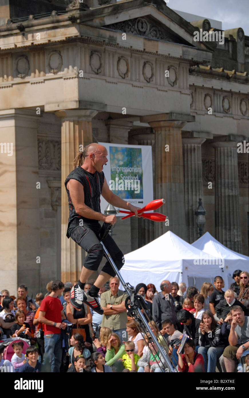 Street performer on unicycle juggling hi-res stock photography and ...