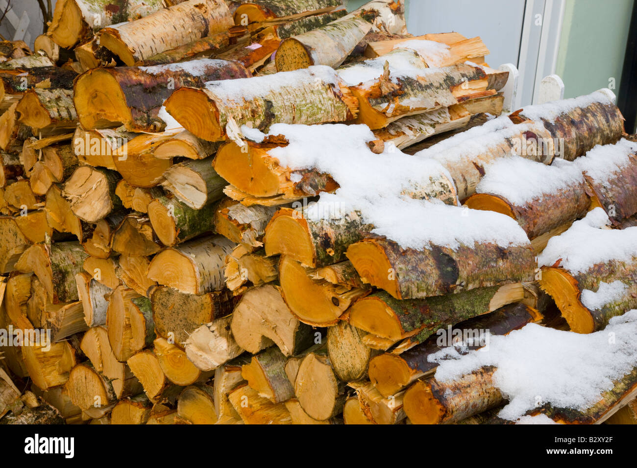 Stack of firewood split and piled up ready for burning Stock Photo - Alamy