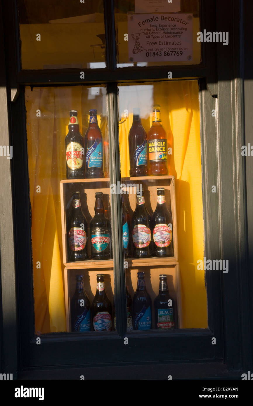 Shop window containing a display of beer bottles Stock Photo - Alamy