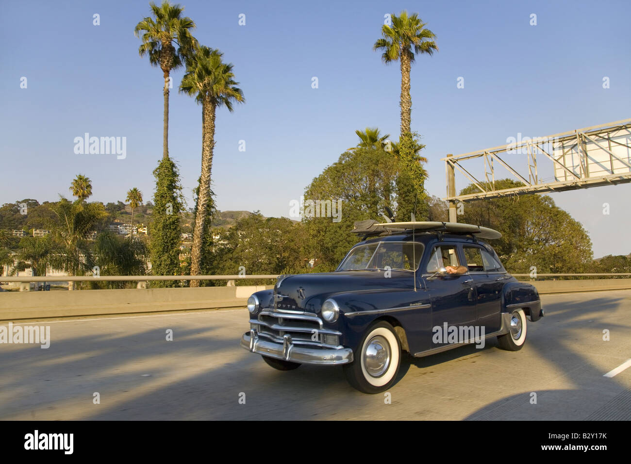 Antique car with surfboard on roof driving north on Route 101 in ...