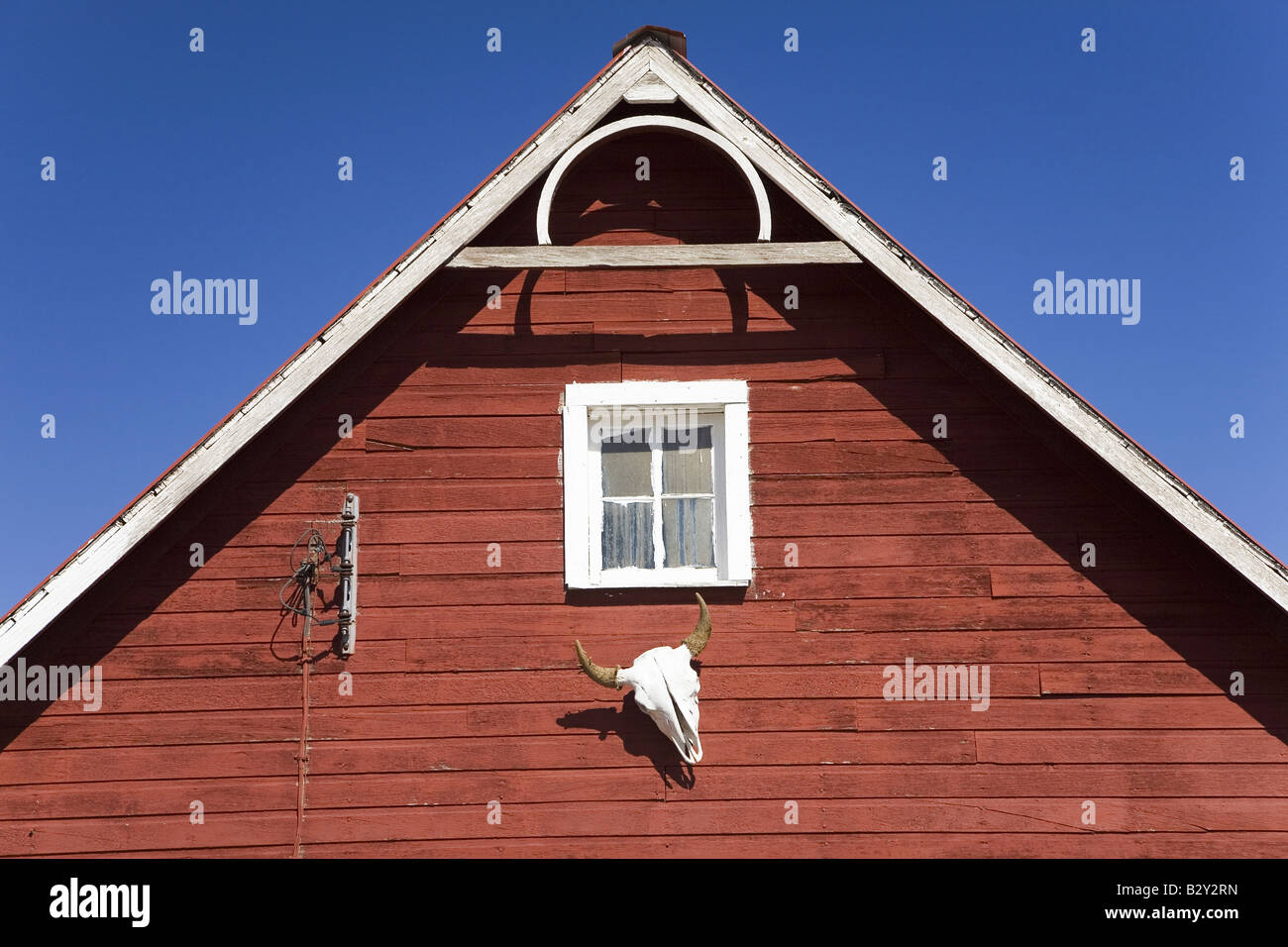 Triangular roof of red barn with cow's scull, near Hot Springs, South ...