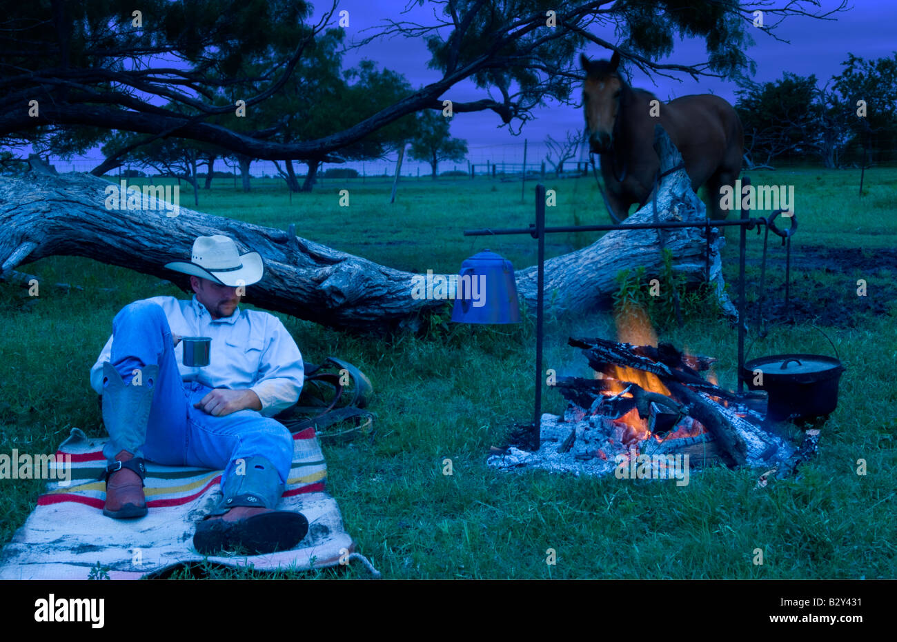 The life of a cowboy in the West USA with night campfire with horses ...