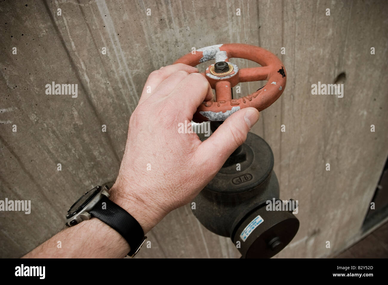 Man s hand turning the handle of a water main MODEL RELEASED Stock ...