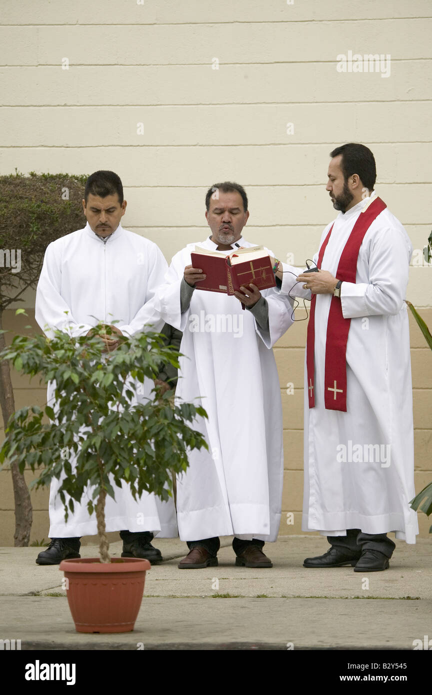 Three priests reading from the bible on Good Friday, Easter, Oxnard ...