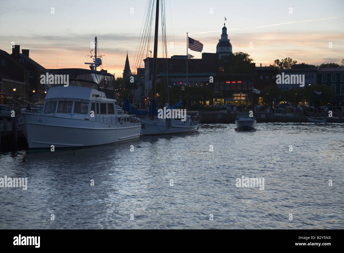 Boat harbor at dusk with historic State Capitol in background ...