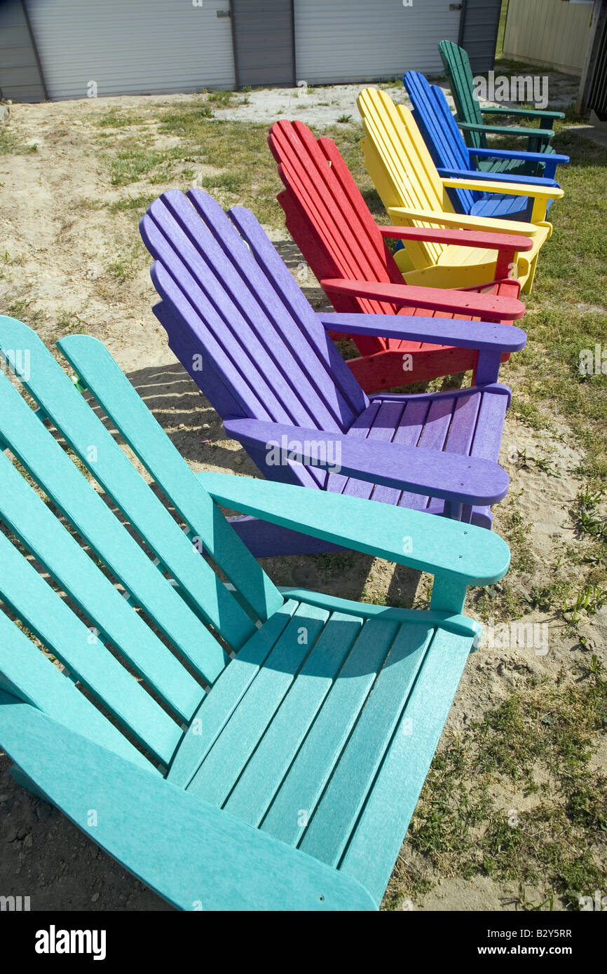 Rainbow colored wooden chairs, known as "Maine Chairs," standing in a ...