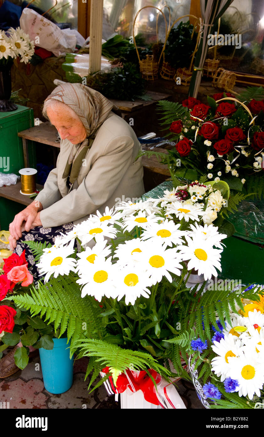 Old Lady Babushkas Selling Flowers At Market In Old Town Center City Of old-lady-babushkas-selling-flowers-at-market-in-old-town-center-city-of