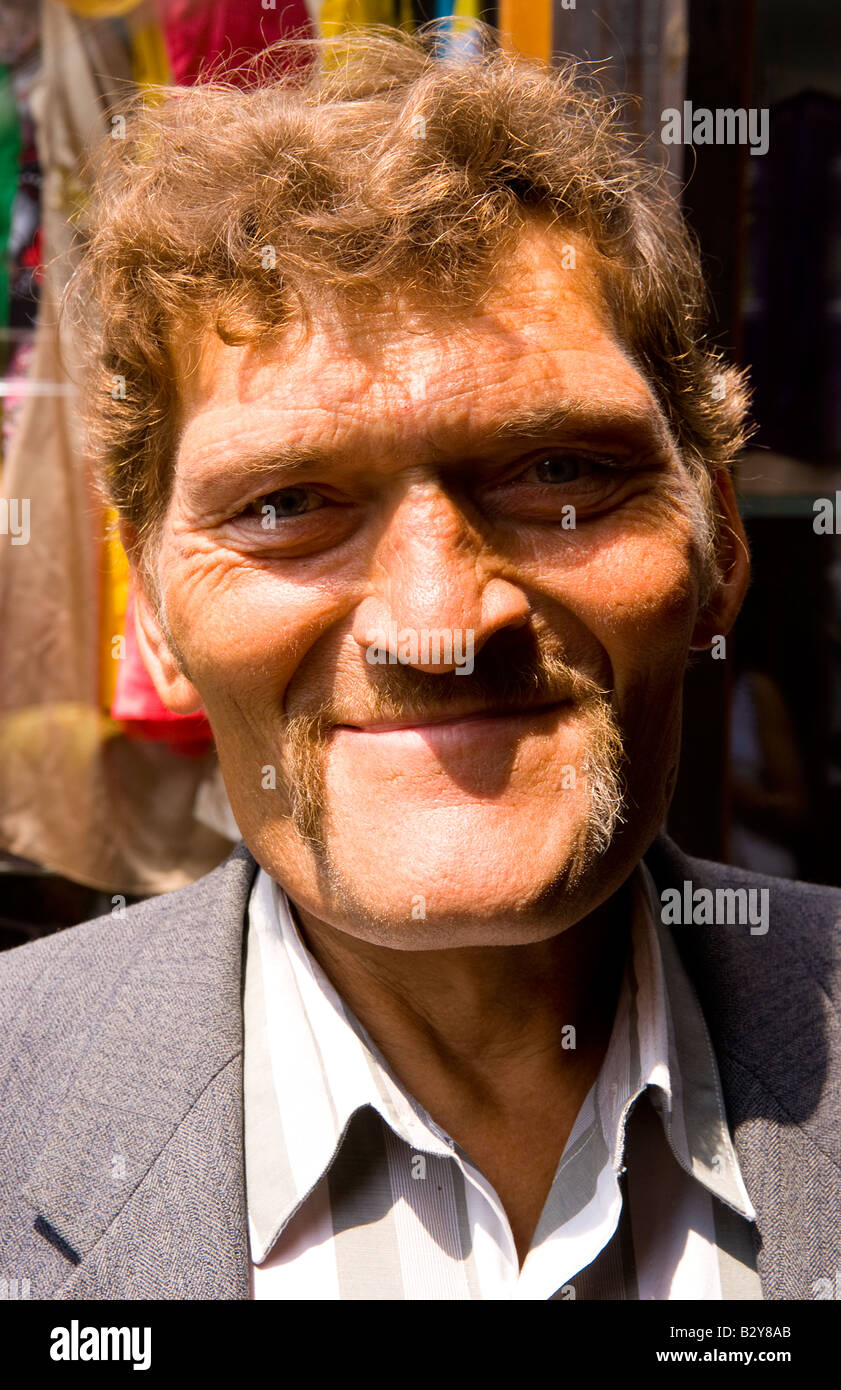 Tough looking giant man with extreme large head in city center in Lviv ...