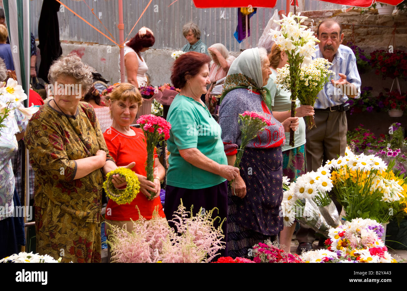 Old lady babushkas selling flowers at market in old town center city of ...