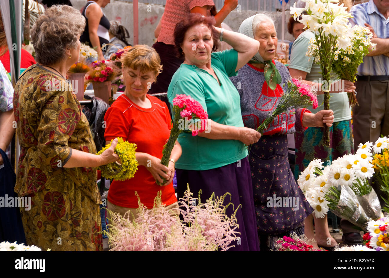 Old lady babushkas selling flowers at market in old town center city of ...