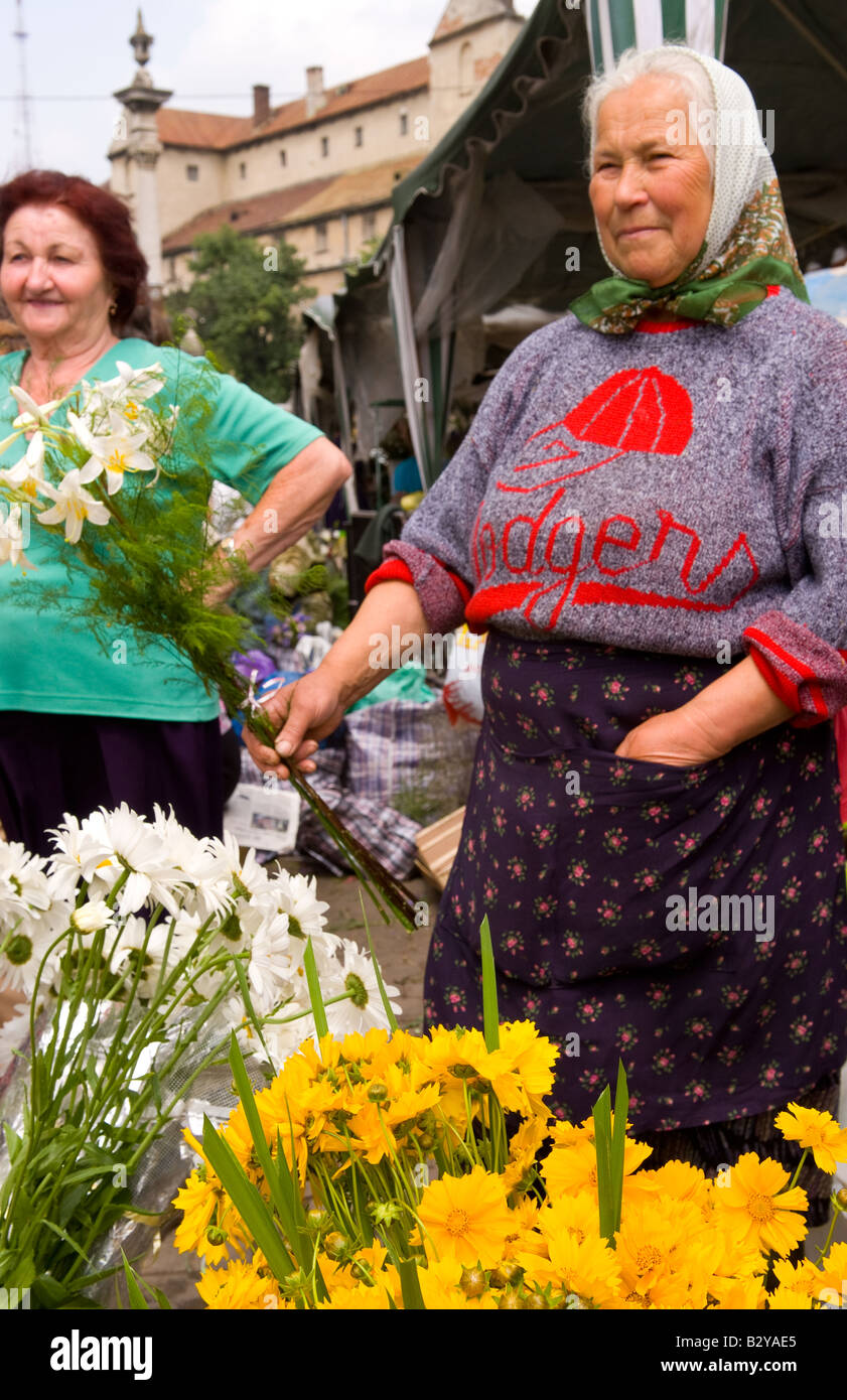 Old lady babushkas selling flowers at market in old town center city of ...
