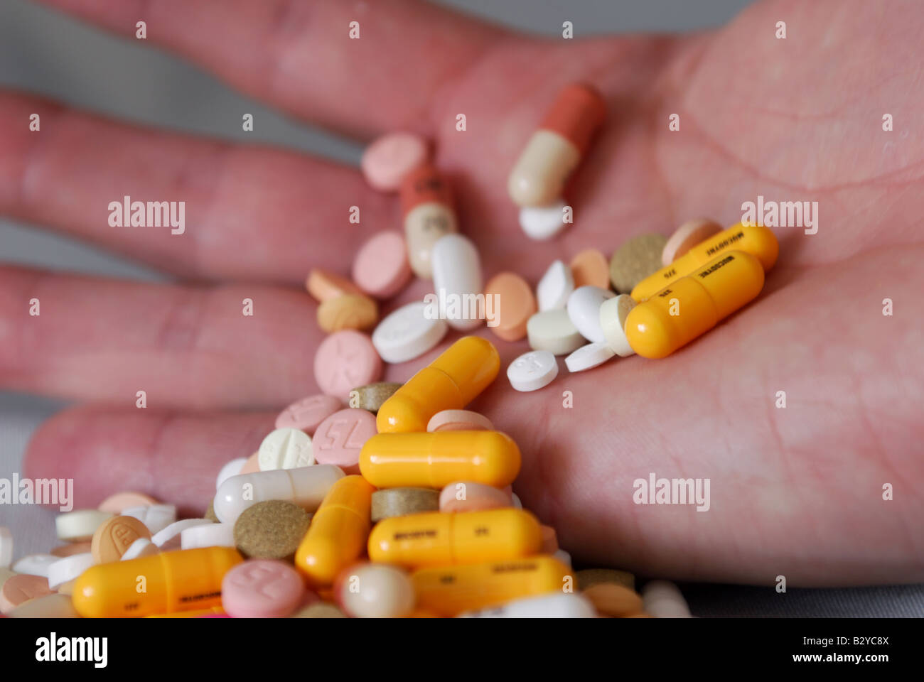 generic image of a handful of pills Stock Photo - Alamy